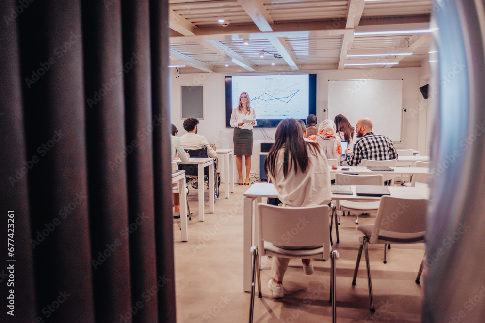 Diverse group of business people having training at the classroom ...