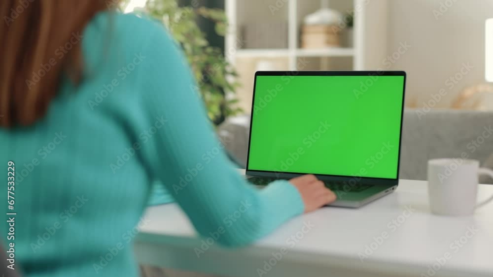 Close-up captures woman using laptop, focusing on hands as they type on ...