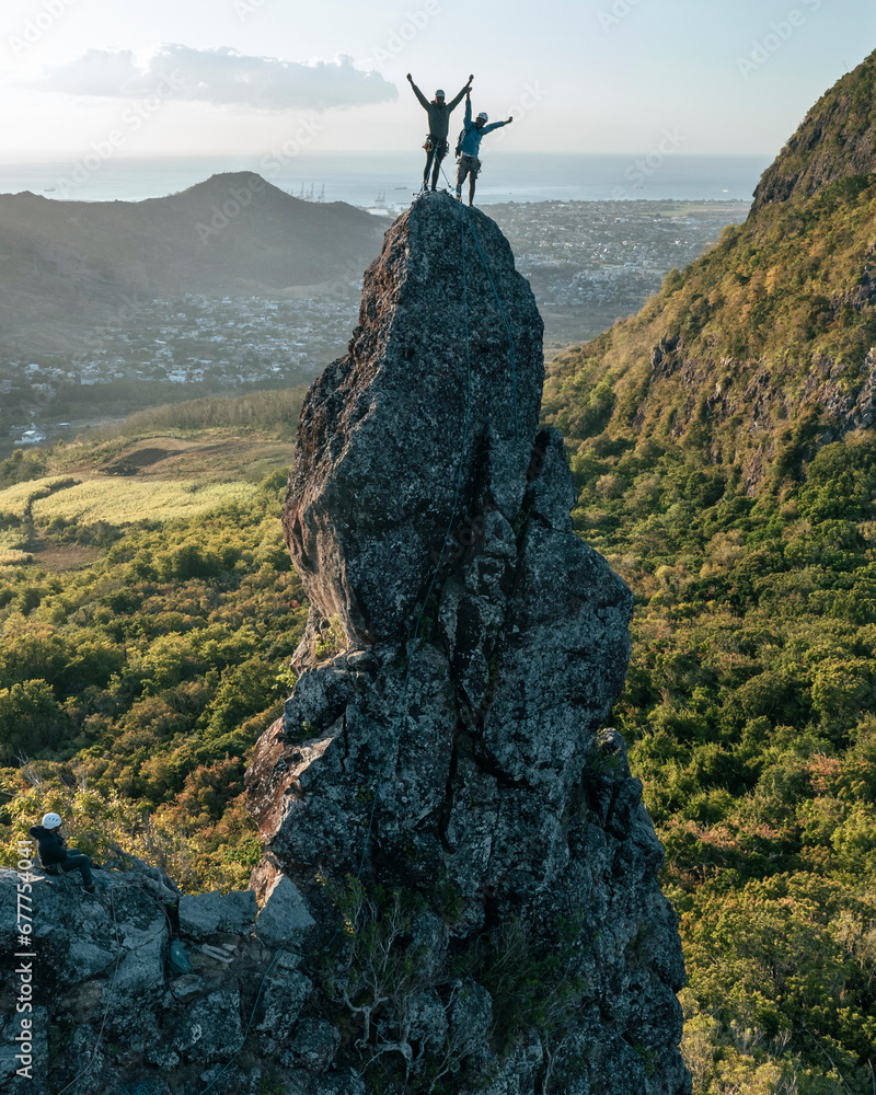 Aerial view of people climbing on Piton Jacob Peak mountain in Port ...