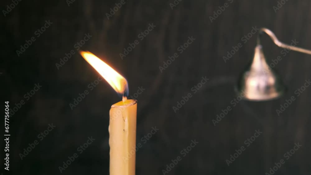 Close-up of extinguish candle in dark, it burns, flame on candle ...