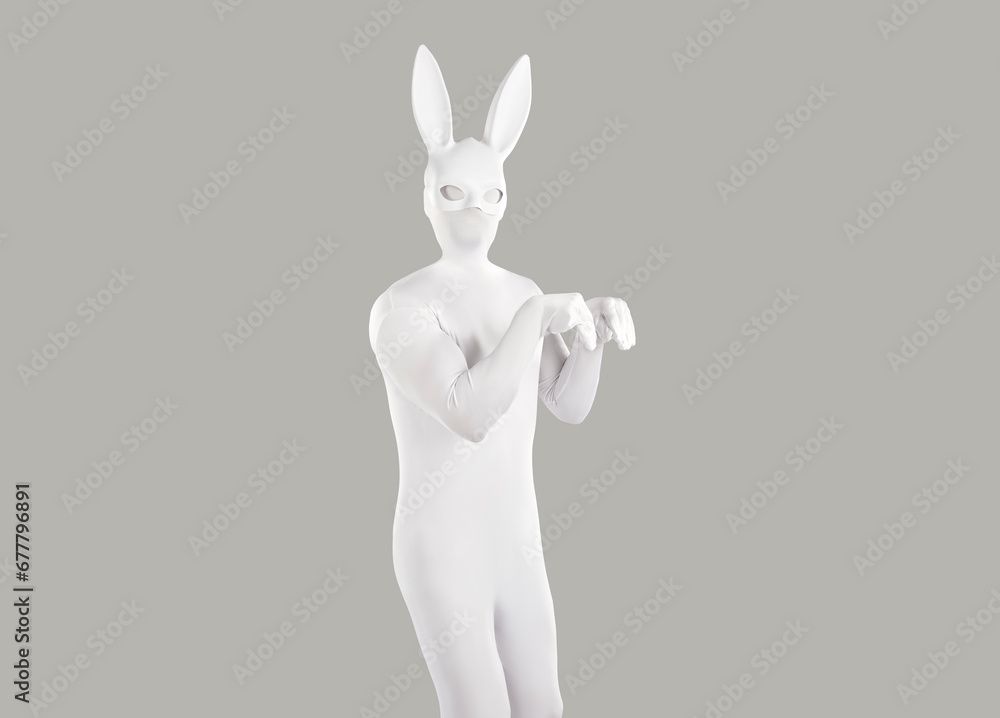 Funny human model pretends to be a bunny. Man disguised in a white skin ...