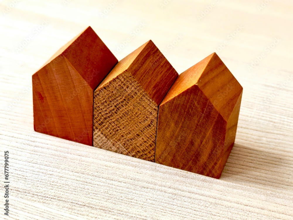 Group of similar wooden tiny toy houses. Wooden models of buildings as ...