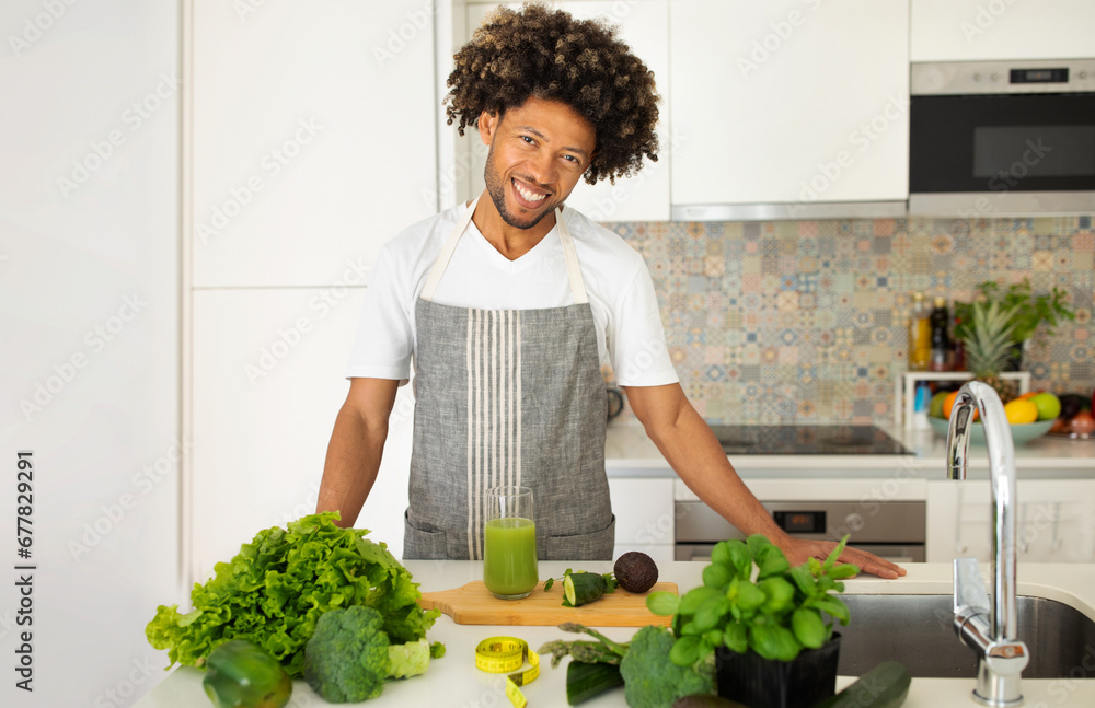 Black man posing with green detox smoothie in glass indoor Stock Photo ...