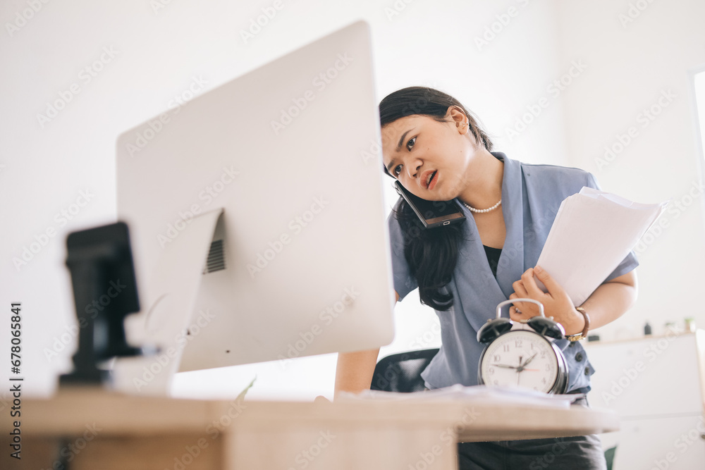 Busy business woman working hard on her desk in office with a lot of ...