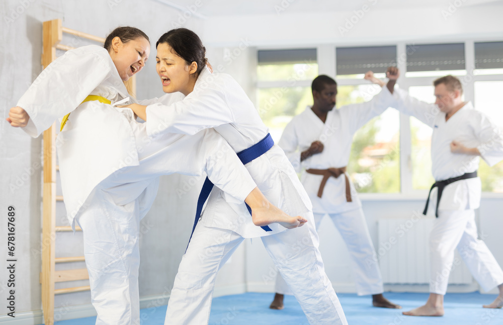 Karate with two female athletes practicing, training and sparring in ...