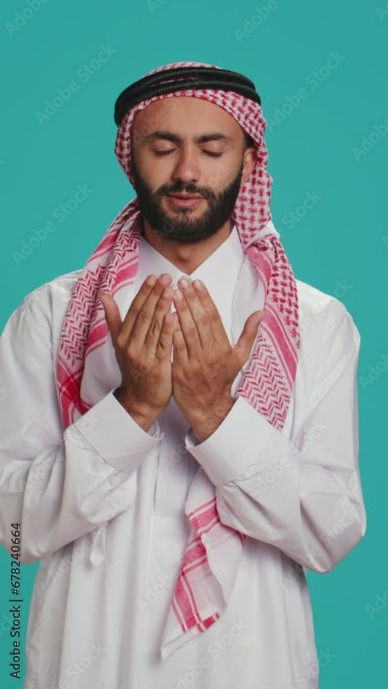 Vertical video Islamic man praying to allah in studio, having hope in ...