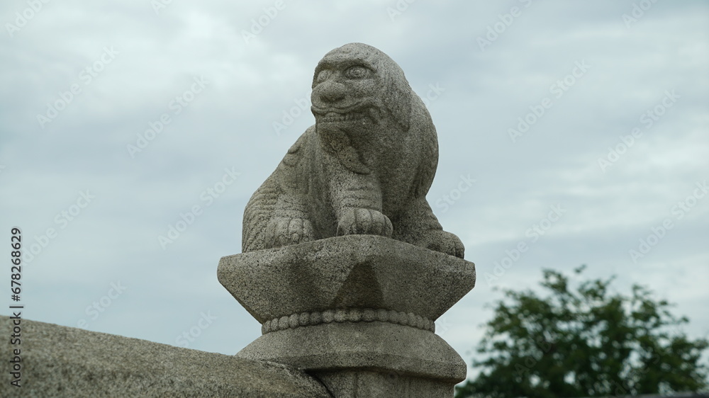Haetae statue of an imaginary animal in front of a traditional building ...