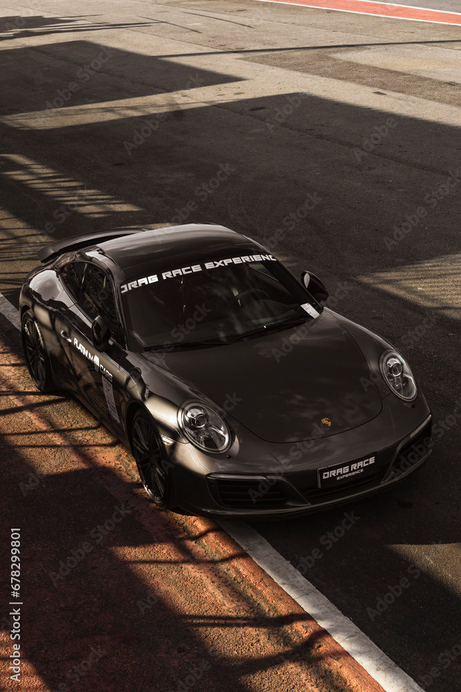 Grey Porsche 911 Carrera High Angle front view, race track background ...