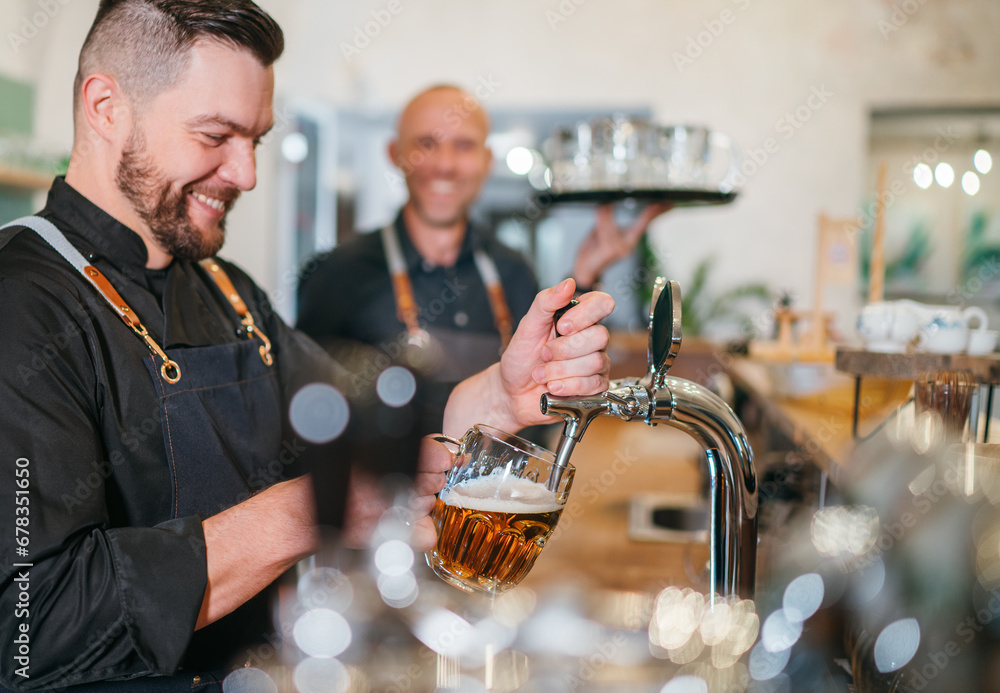 Stylish bearded barman dressed black uniform beer tapping at bar ...