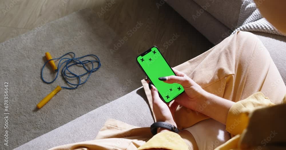 Sporty girl swiping smartphone screen with chromakey. Advertising of ...