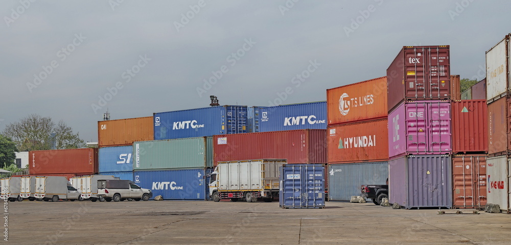 Stacked shipping containers and utility vehicles in Thai capital ...