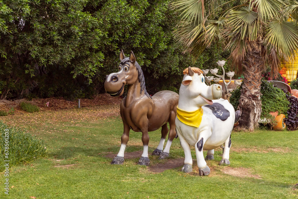 Large decorative fabulous figures of a cow and a horse stand near the ...