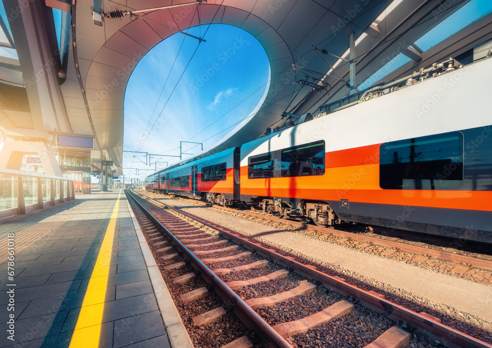High speed train on the modern railway station at sunset in Graz ...