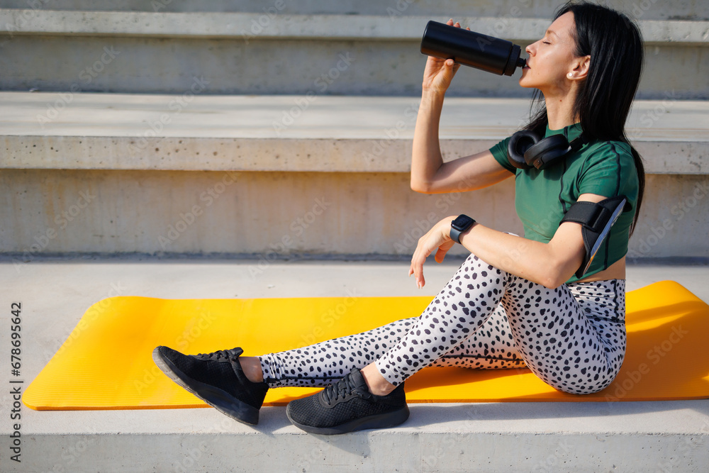 Athletic Woman Taking a Water Break at the Stadium Stock Photo | Adobe ...