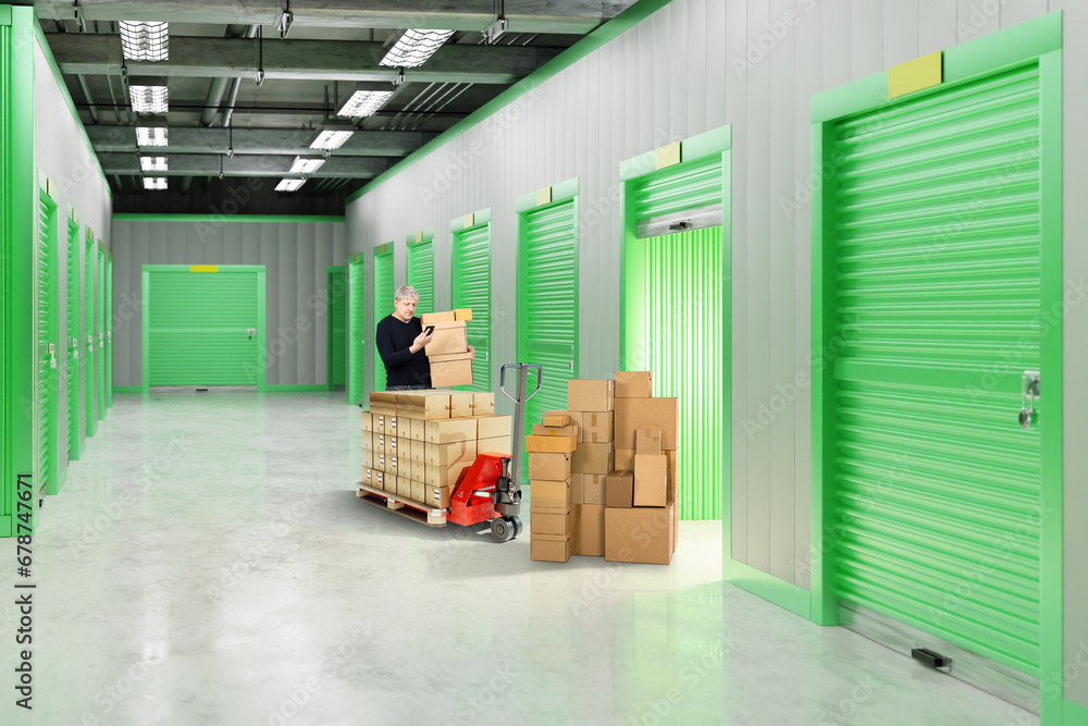 Man rents storage unit. Warehouse with gates to containers for ...