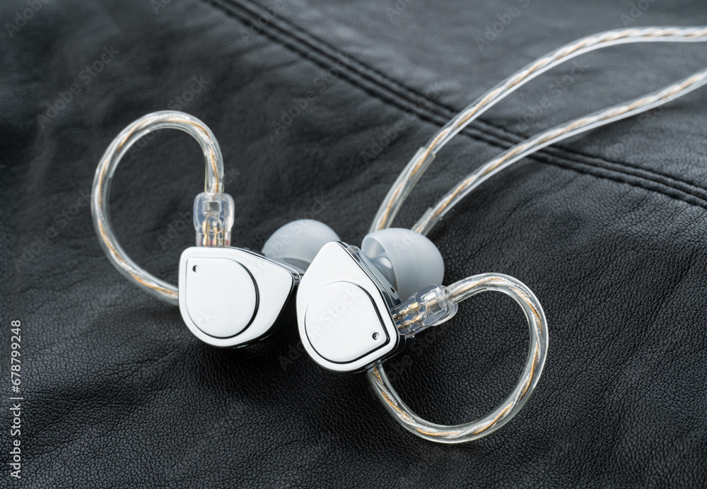 In ear monitor on a tablature background. Custom in-ear monitors with ...