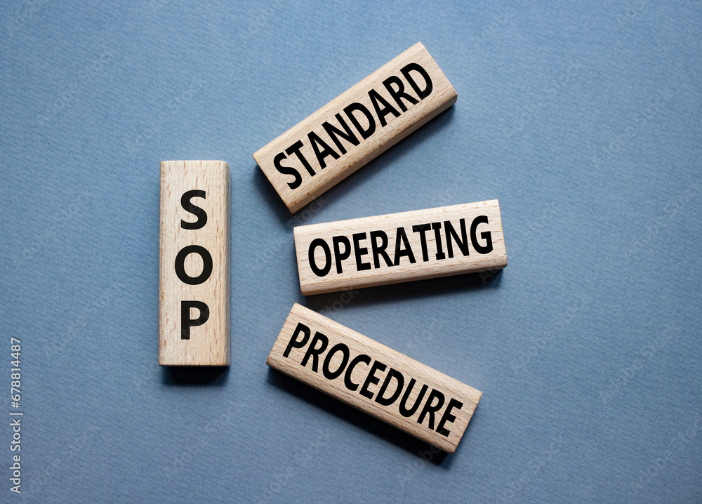 SOP - Standard Operating Procedure symbol. Wooden blocks with word SLA ...