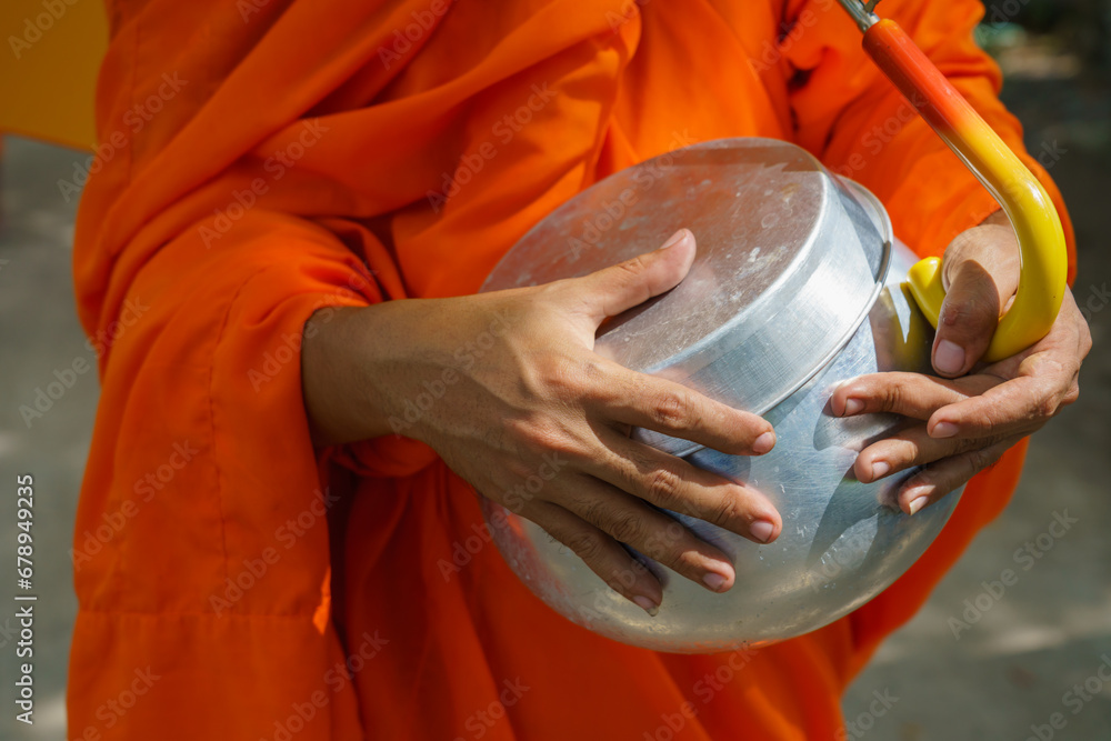 Buddhist monks carrying their alms bowls in southern Vietnam. Stock Photo | Adobe Stock