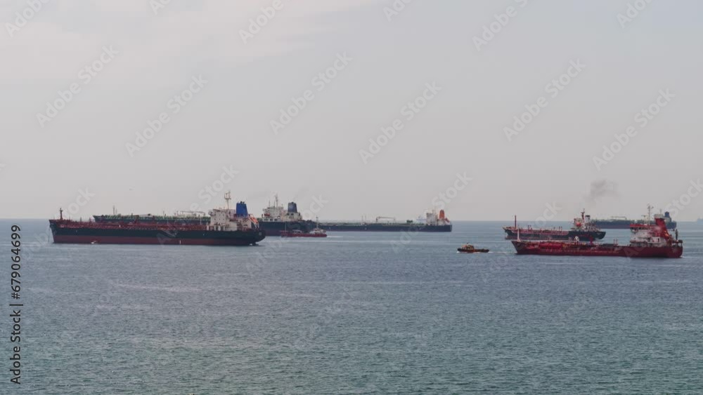 Dry cargo ships on the roads in the waters of the port of Istanbul. Tug ...