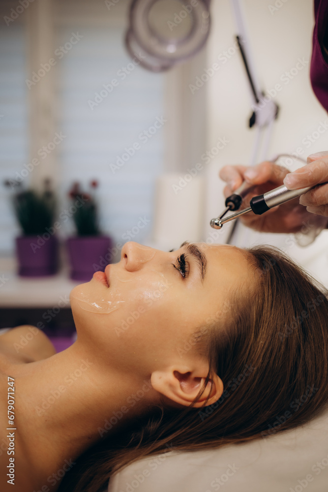 Beautiful woman receiving facial microcurrent procedure for lifting ...