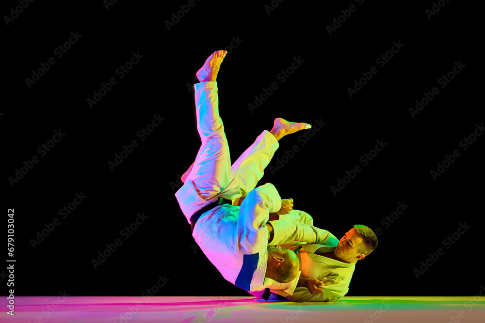 Athletic men, professional sportsmen during match. Judo fighter ...