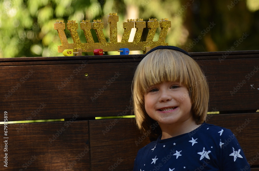 Cute child rejoices at Hanukkah. Children and Jewish holidays ...