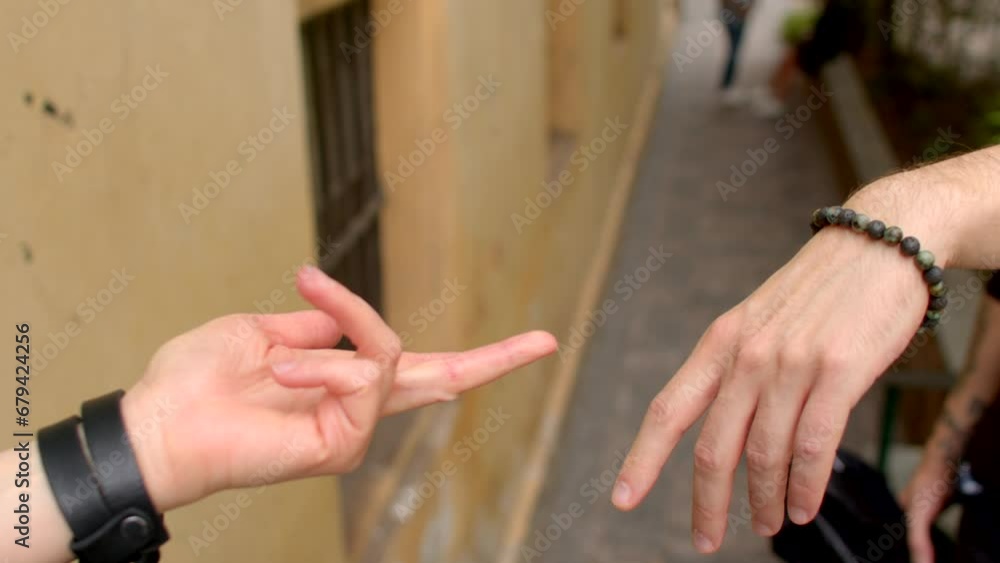 Close up of hands reaching, fingers intertwining is tactile connection ...