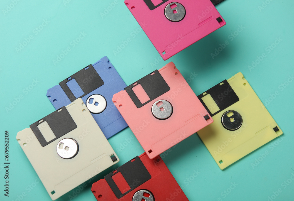 Floating colored retro 80s floppy disks on a blue background ...