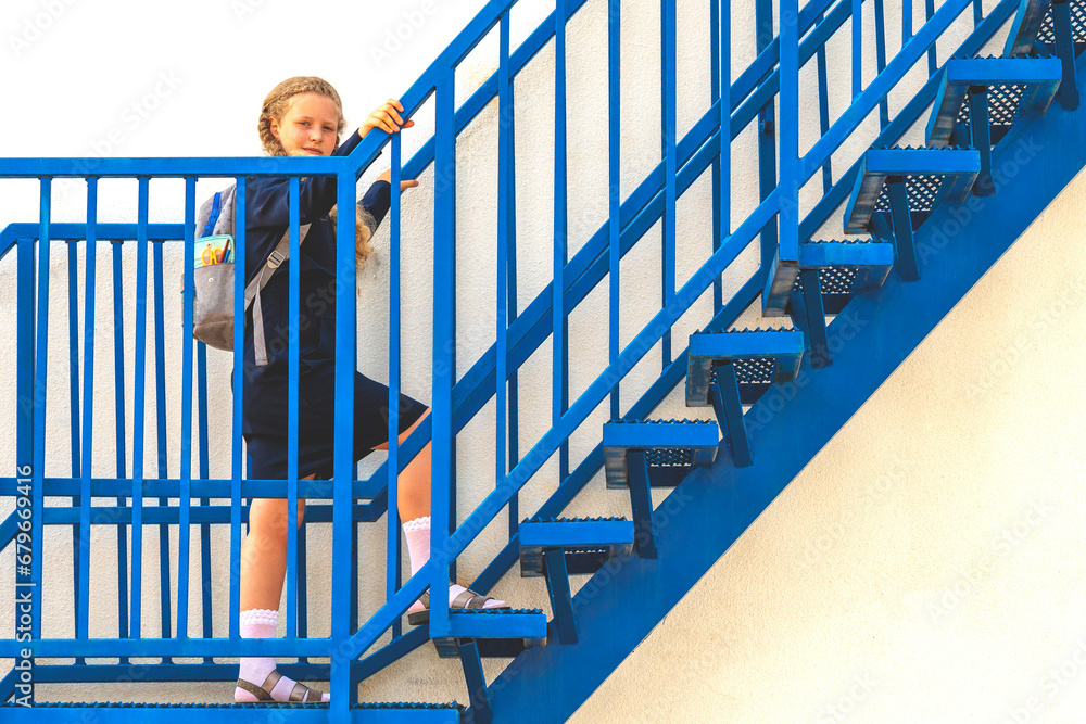 Schoolgirl climbs the stairs. girl in a uniform go up the stairs Stock ...