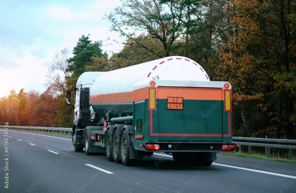 Petrol cargo truck driving on highway hauling oil products. Fuel ...