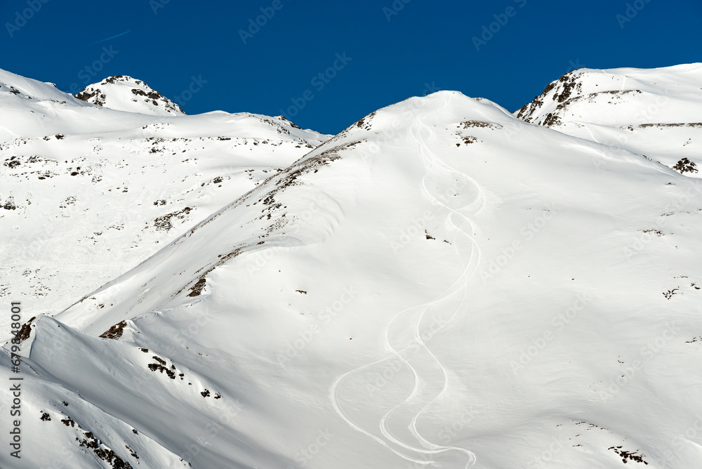 Three single ski tracks in untouched deep snow, Penken ski resort ...