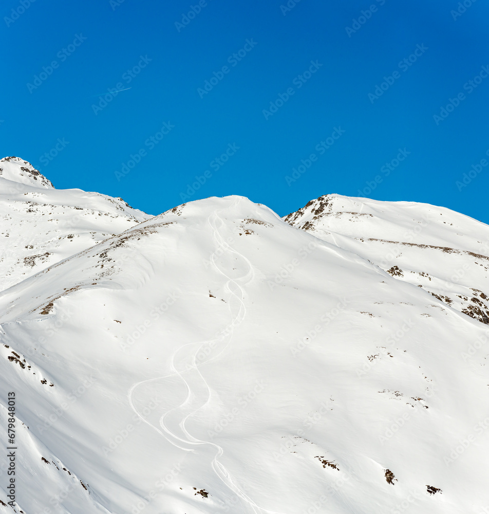 Three single ski tracks in untouched deep snow, Penken ski resort ...