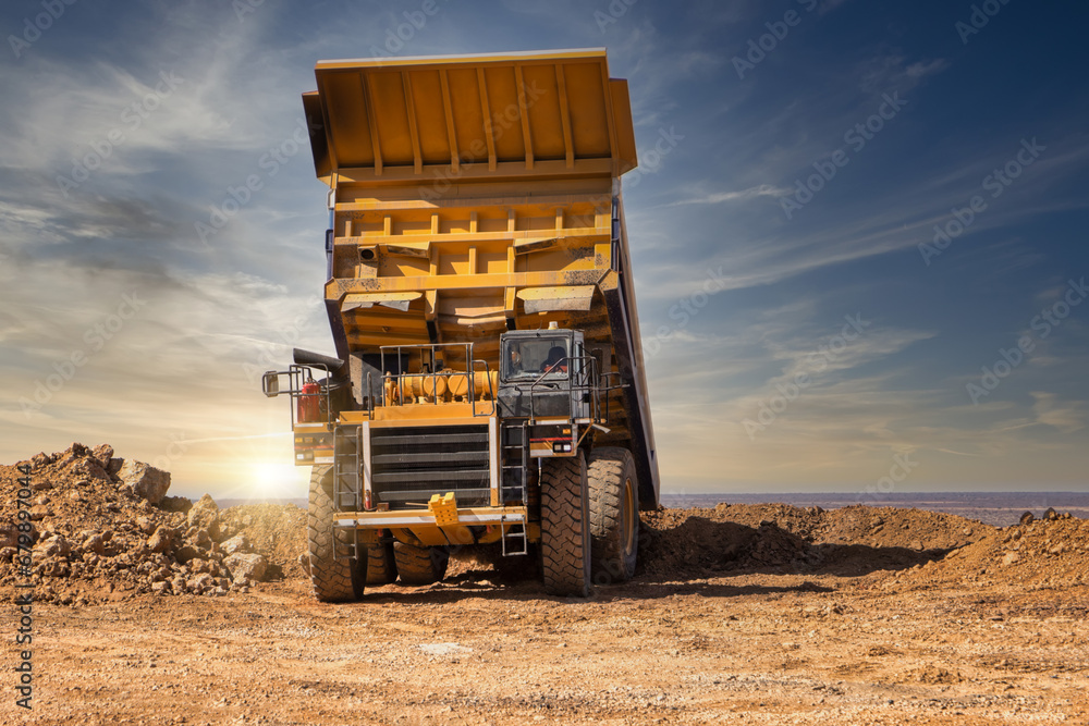 mining truck tipping the load at a diamond mine at sunset Stock Photo ...
