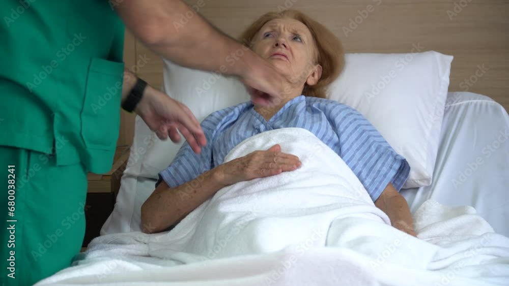 senior woman patient lying on bed with doctor push hand on abdomen ...