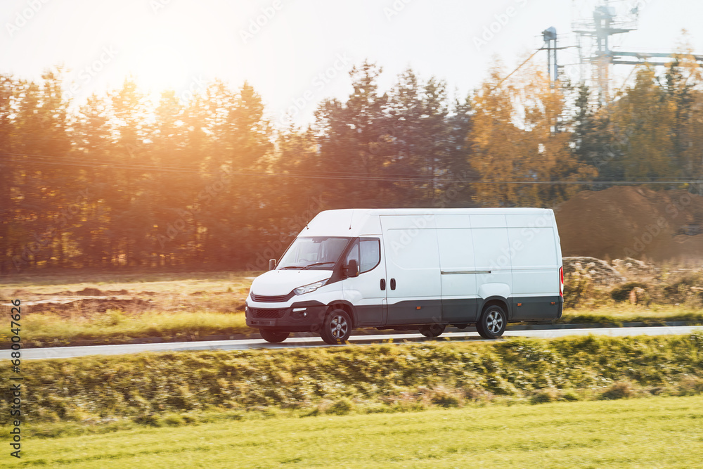 A commercial van truck on the highway, delivering goods and products ...