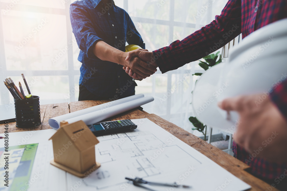 Architect and engineer construction workers shaking hands after ...