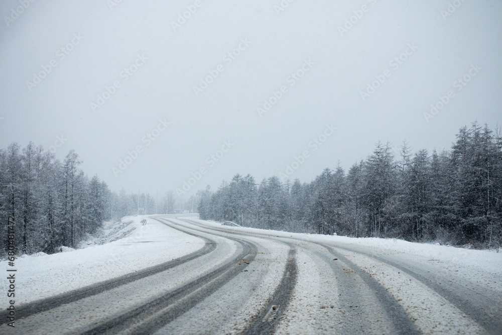 Photo of the winter road during the snowfall in Magadan, Russia. Snow ...