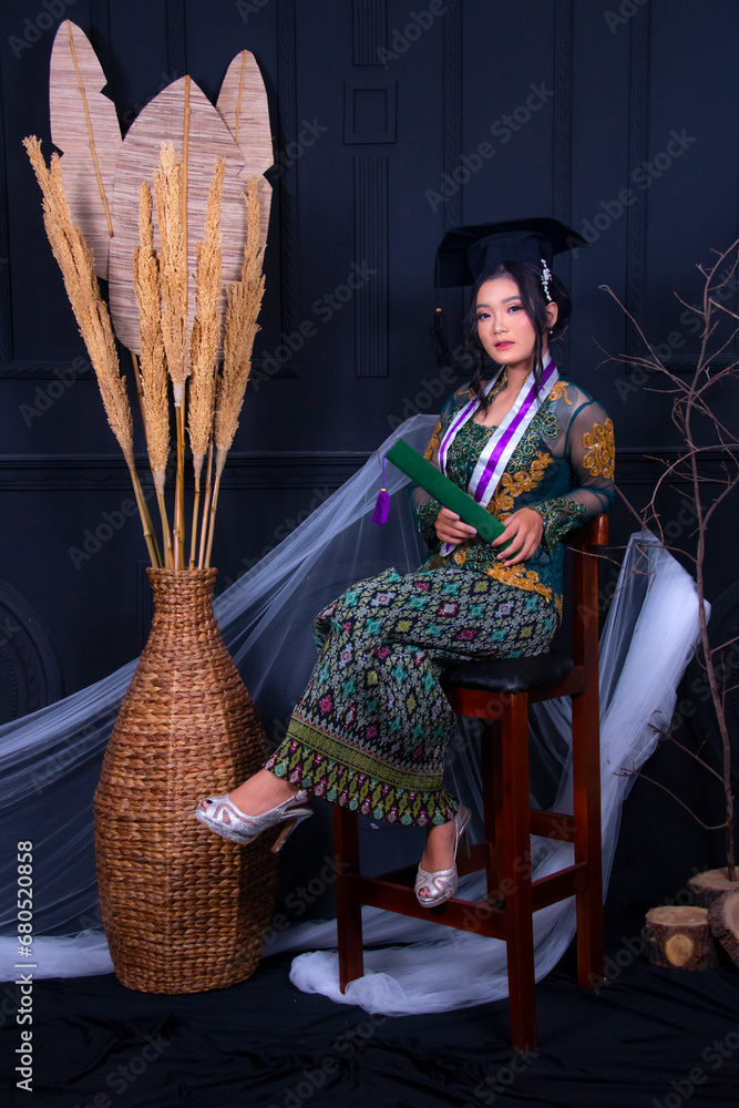 beautiful asian woman sitting on a chair at the graduation session in ...