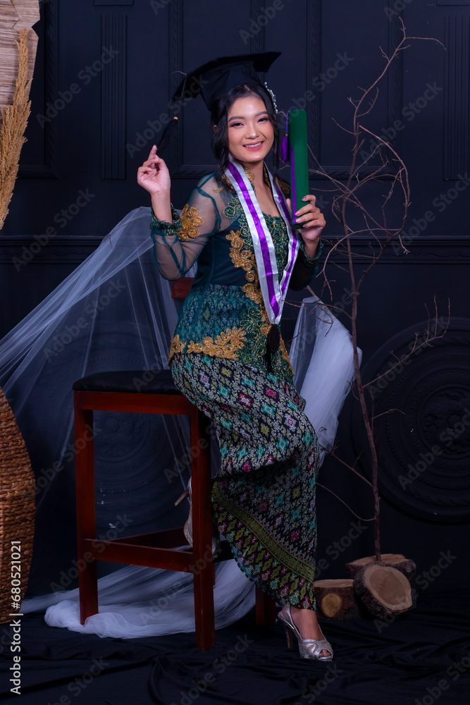 beautiful exotic Asian woman graduating smiling happily holding diploma ...