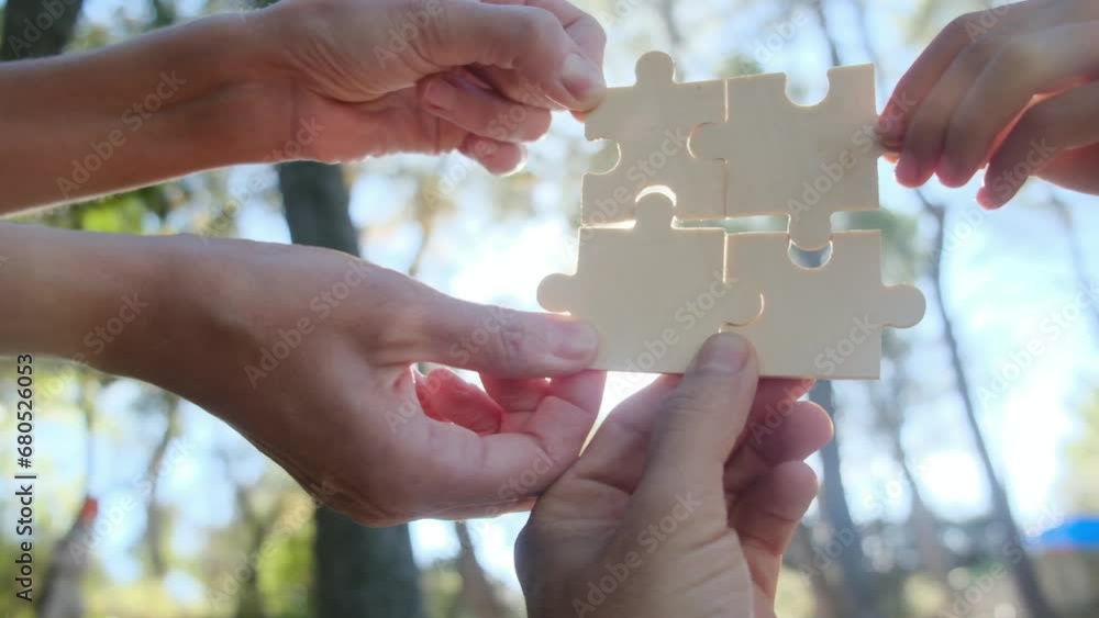 Diverse hands unite, expertly crafting a puzzle mosaic—a vivid tableau ...