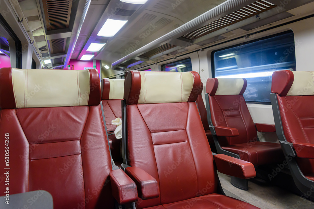 Red leather seats in the first class carriage of a train in the ...