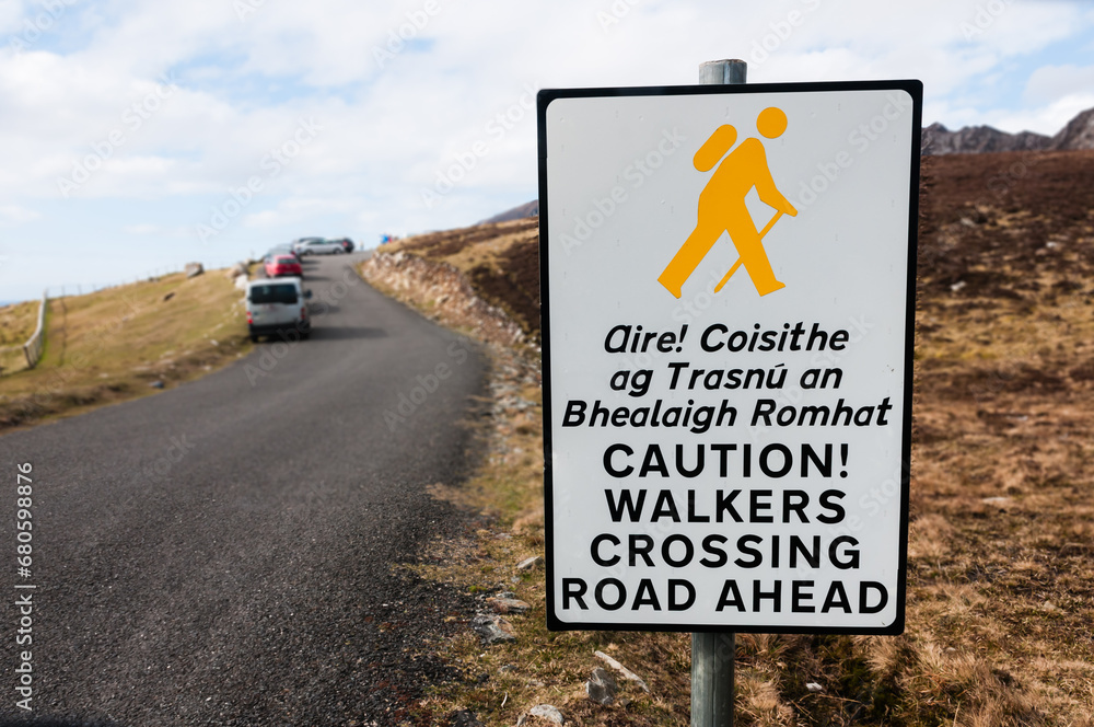 Sign in Irish and English, warning drivers that walkers are crossing ...