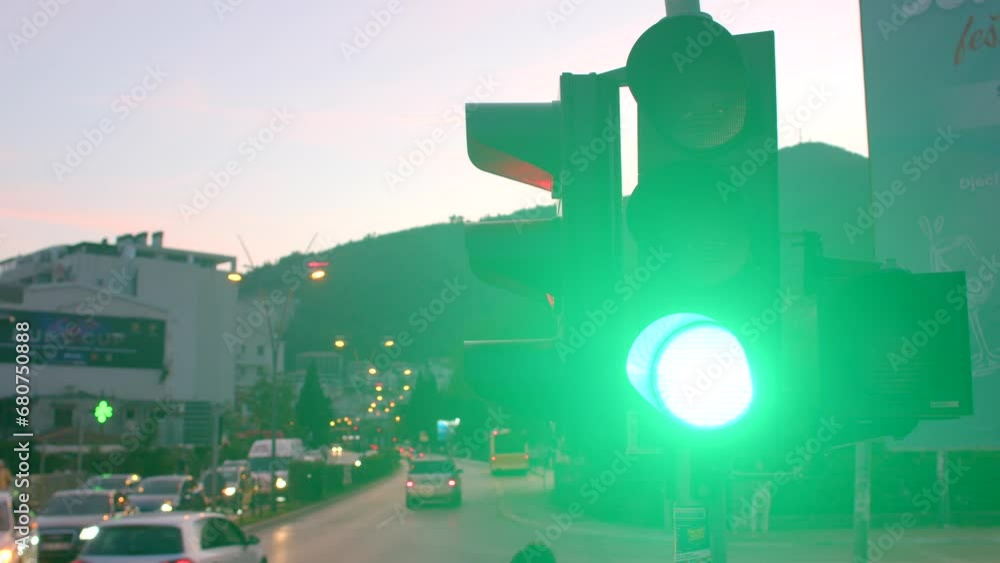 Green traffic light regulates urban traffic, signaling vehicles to ...