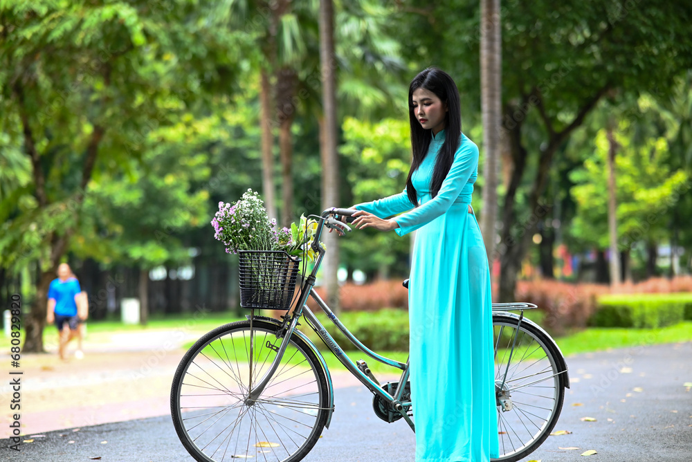 A Young Girl Wearing A Jade green Ao Dai The Traditional Costume Of a-young-girl-wearing-a-jade-green-ao-dai-the-traditional-costume-of