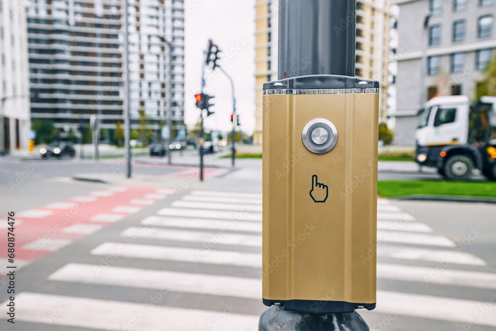 Press button to cross a city street by safe pedestrian path by green ...