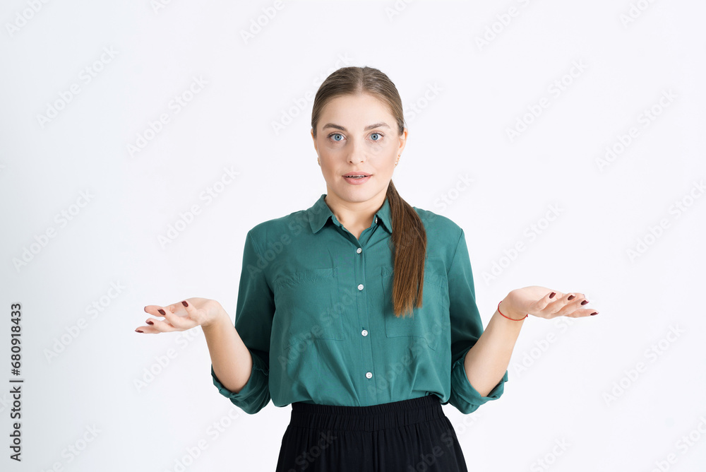 Attractive young woman shrugs her shoulders and spreads her arms to the ...