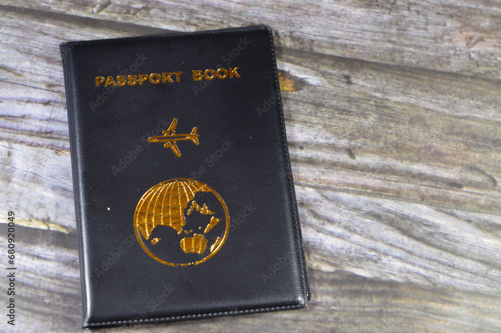 Black passport book with a plane and the globe earth on its cover ...