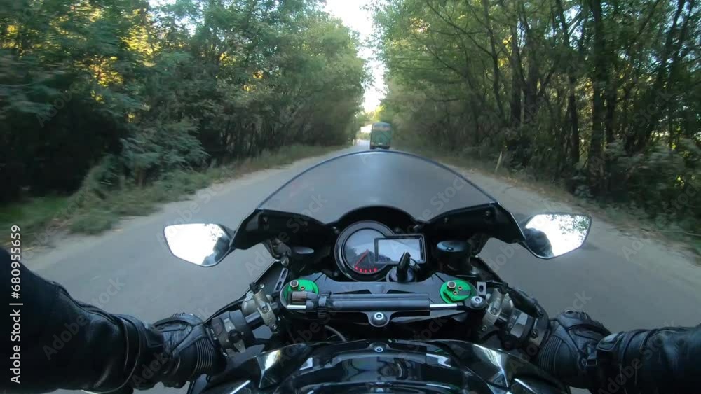 Point of view of a motorcycle rider rides in country road with traffic ...
