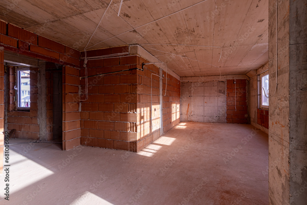 Unfinished room interior of building under construction. Brick red ...