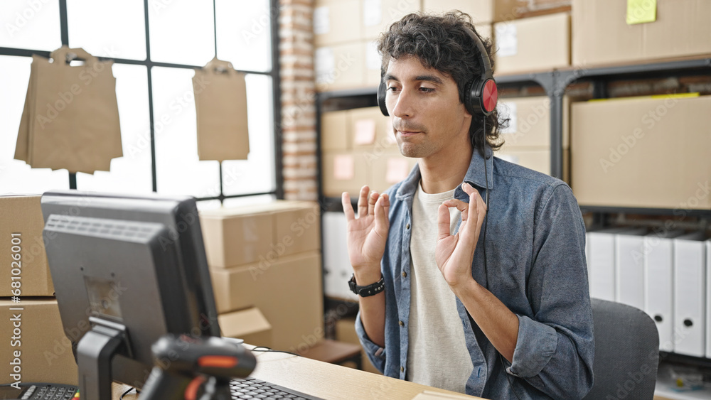 Young hispanic man ecommerce business agent having video call at office ...